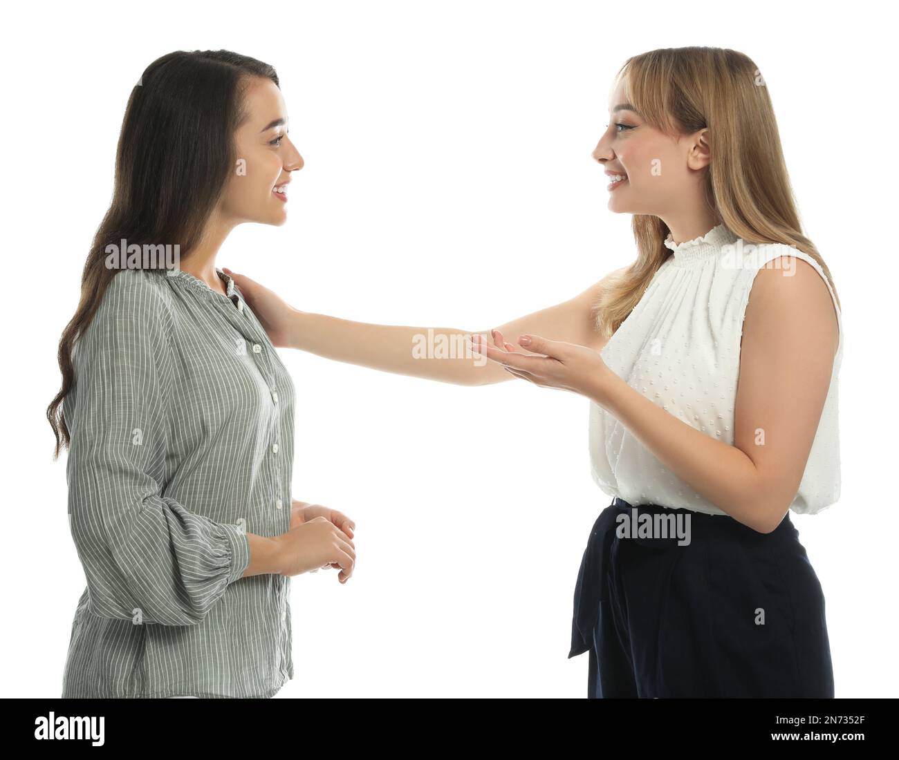 Young women in casual clothes talking on white background Stock Photo ...