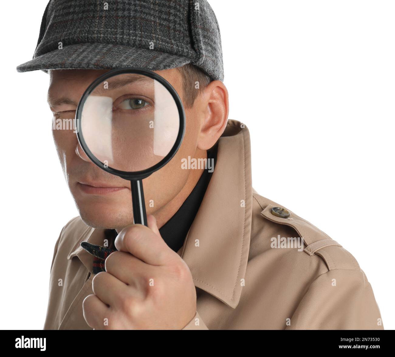 Male detective looking through magnifying glass on white background ...