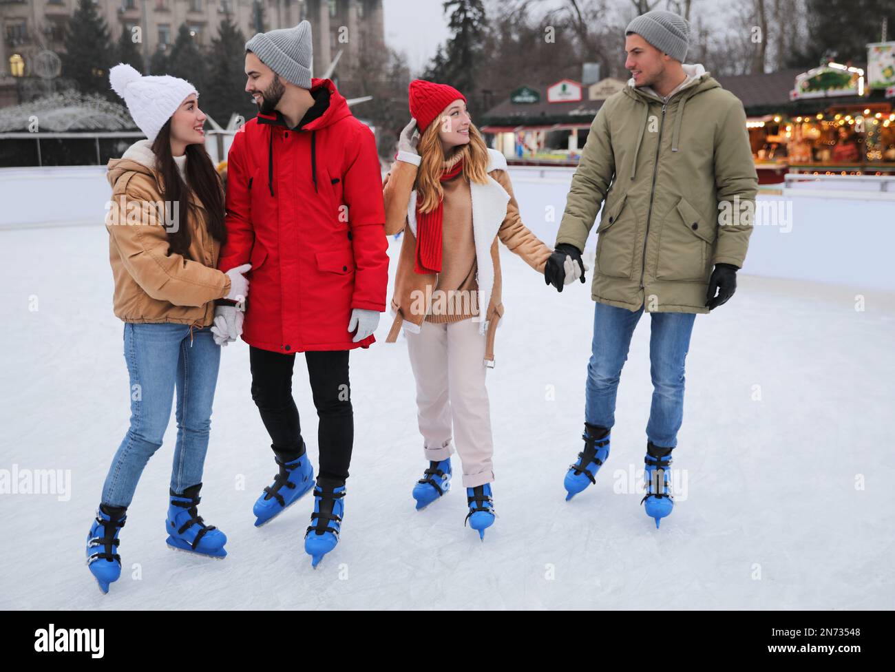 Group of friends at outdoor ice skating rink Stock Photo - Alamy