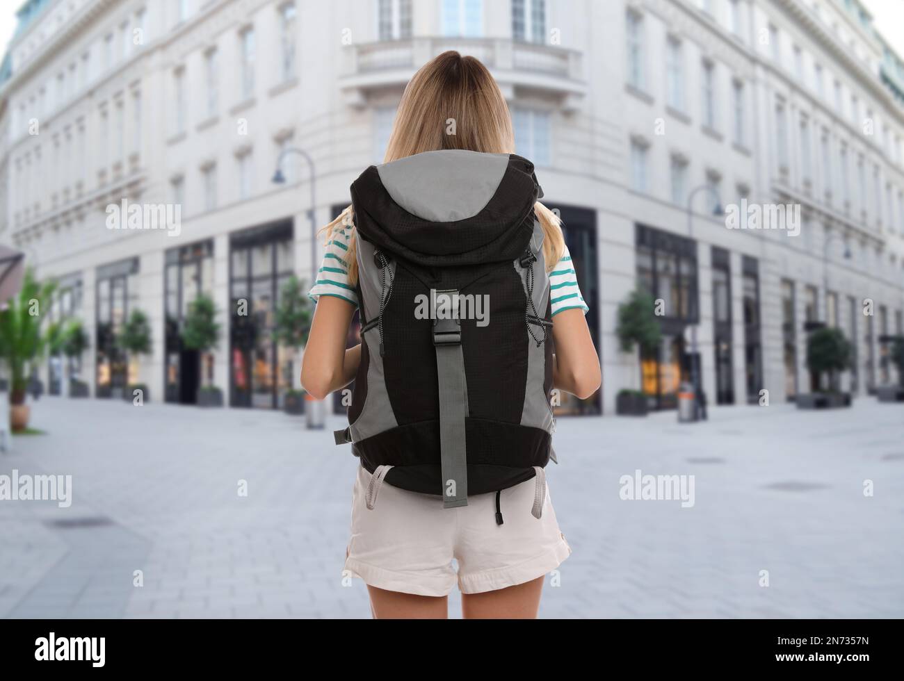 Traveler with backpack in foreign city during summer vacation, back ...