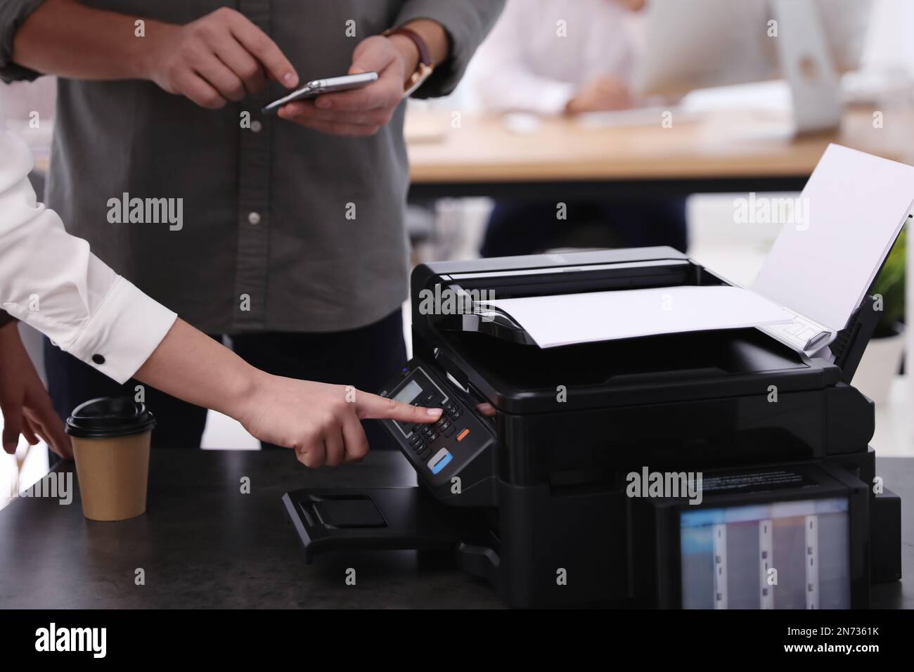 Employees using modern printer in office, closeup Stock Photo - Alamy