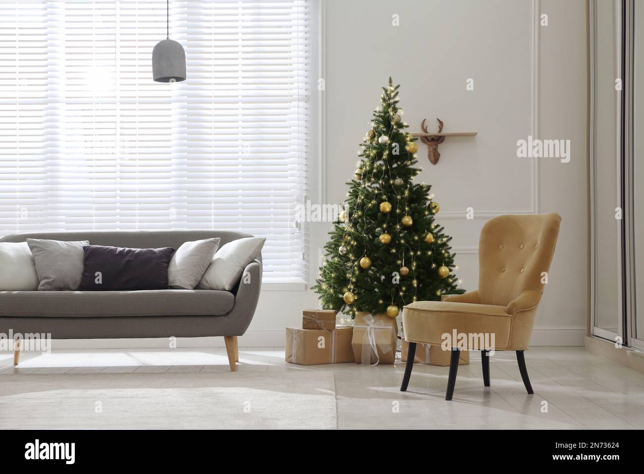 Beautiful Christmas tree and sofa in contemporary living room. Interior ...