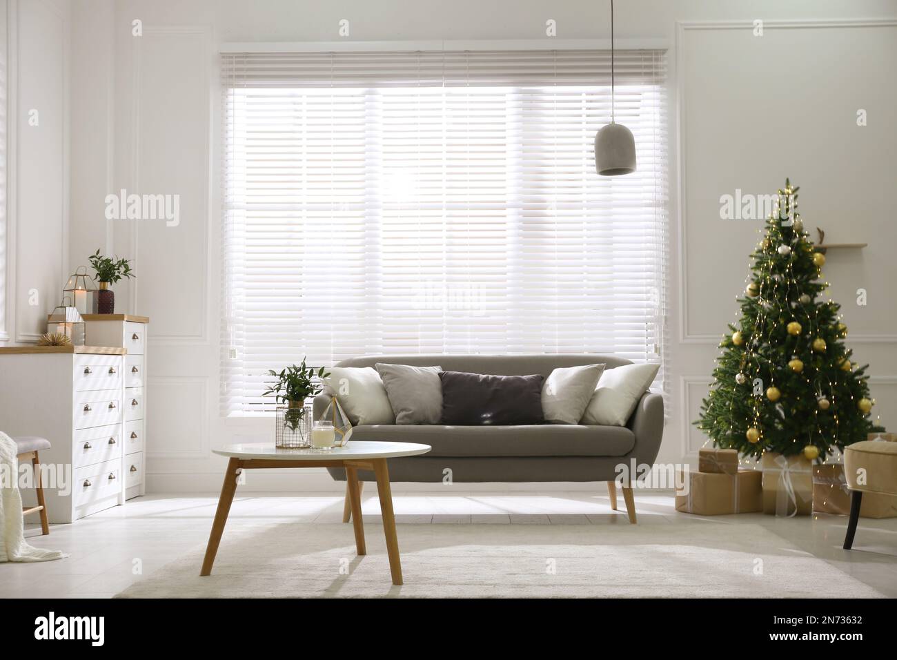 Beautiful Christmas tree and sofa in contemporary living room. Interior ...