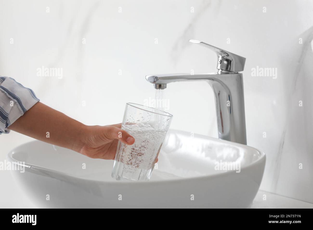 Woman Filling Glass With Water From Faucet Over Sink Closeup Stock