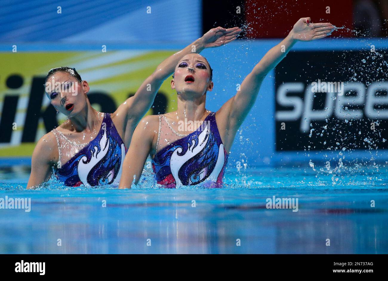 China's Jiang Tingting and Jiang Wenwen perform their routine in the synchronized swimming duet ...