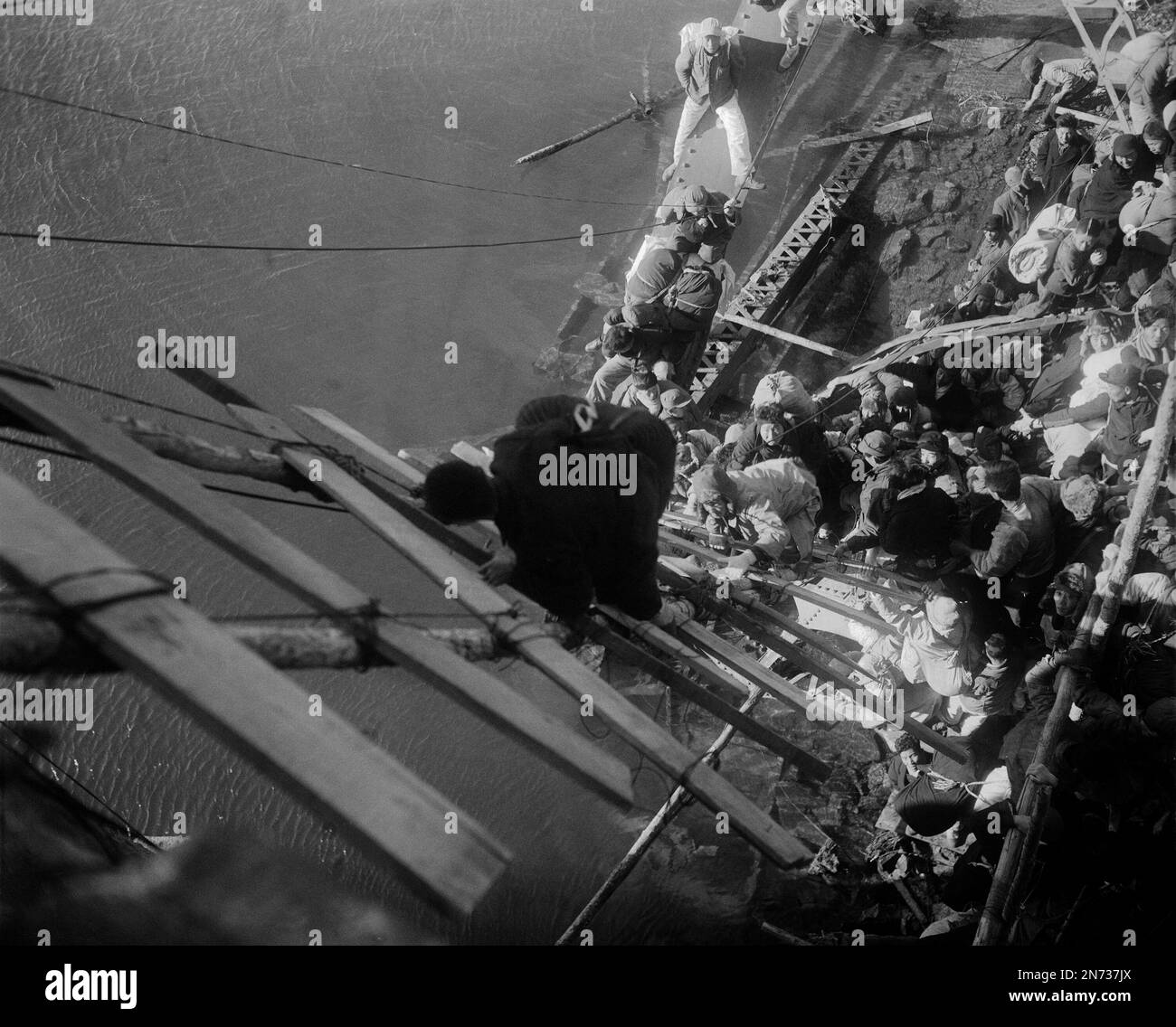 North Korean refugees crawl over twisted girders and climb flimsy ...