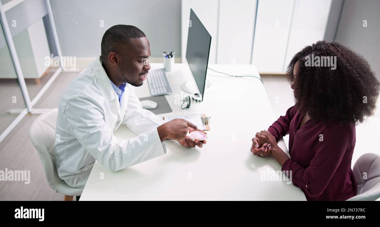 Gynecologist Consulting Woman On Diaphragm Contraception And Birth ...