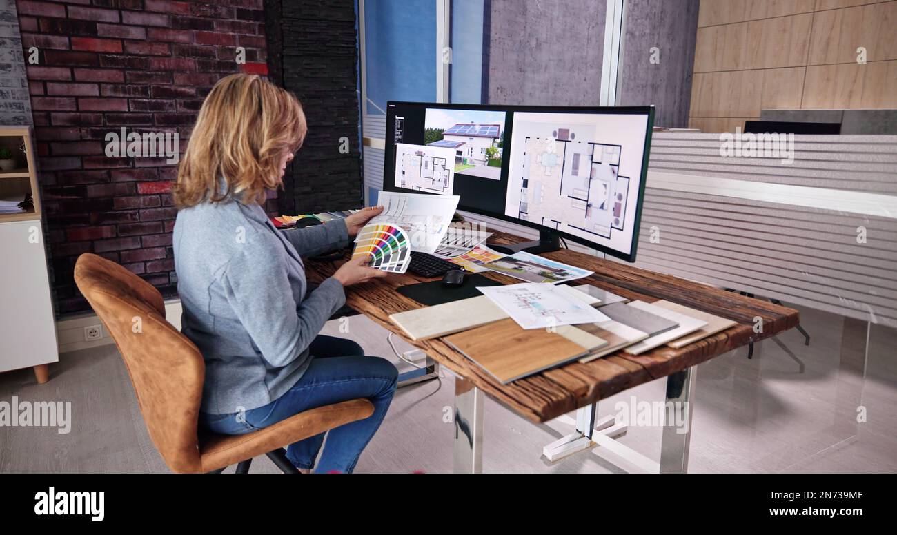 Side View Of Real Estate Designer Working On Computer In Office Stock ...
