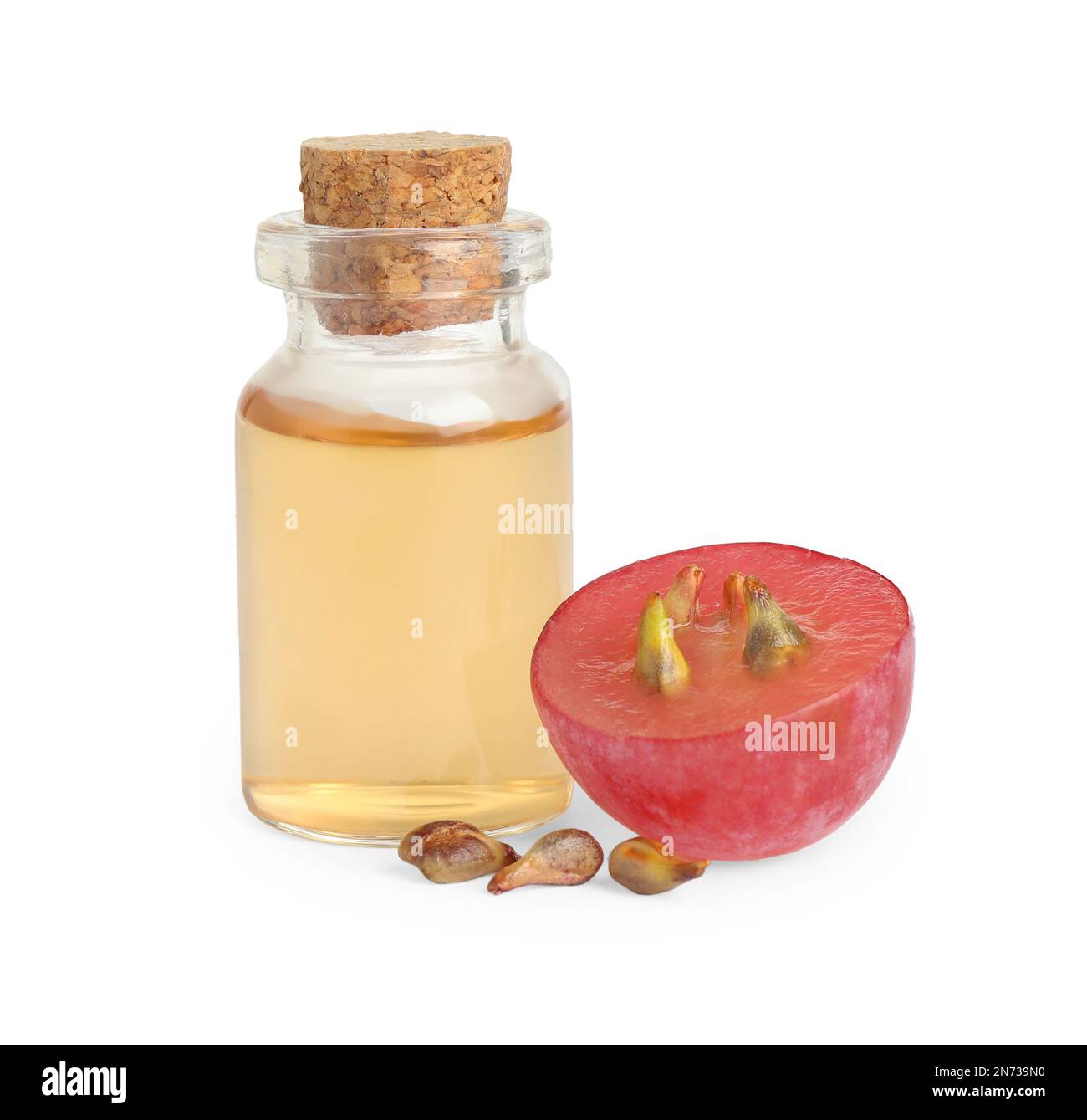 Organic red grape, seeds and bottle of natural essential oil on white ...
