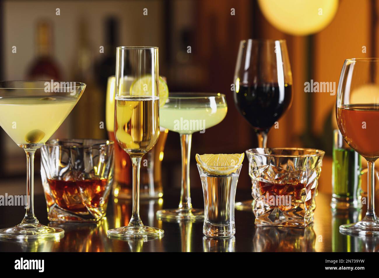 Different alcohol drinks on table in bar Stock Photo - Alamy