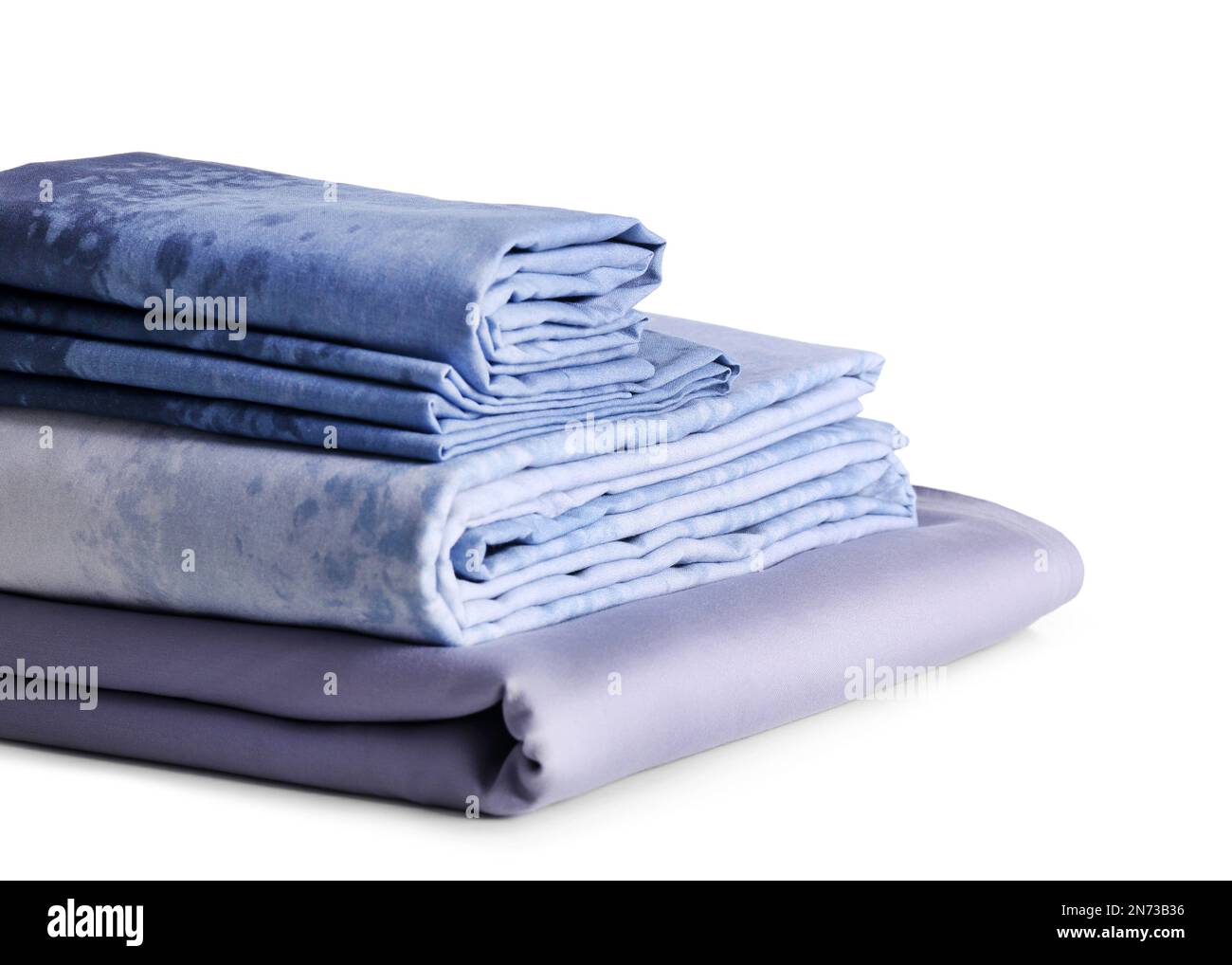 Stack of clean bed linen isolated on white Stock Photo - Alamy