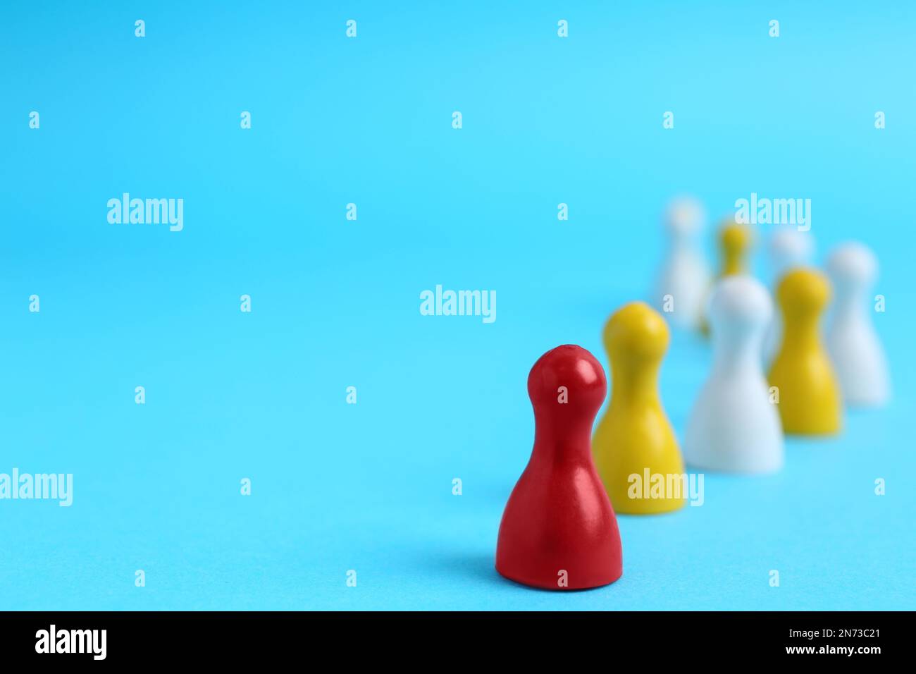 Red playing piece with following group on light blue background, space ...