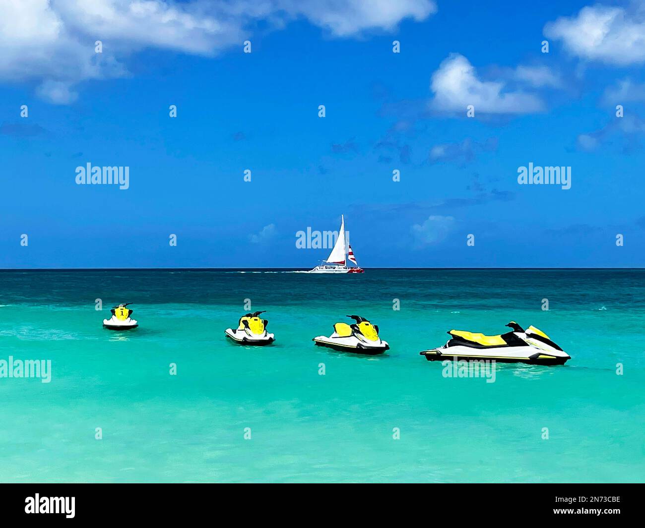 Personal watercraft lined-up on the Caribbean sea, off the coast of ...
