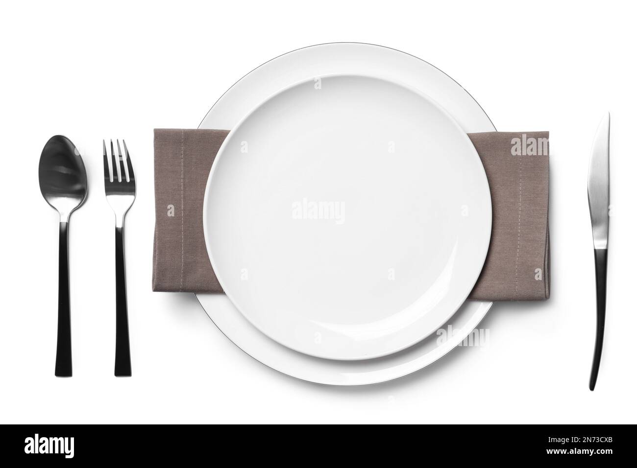 Setting plates on table Cut Out Stock Images & Pictures - Alamy
