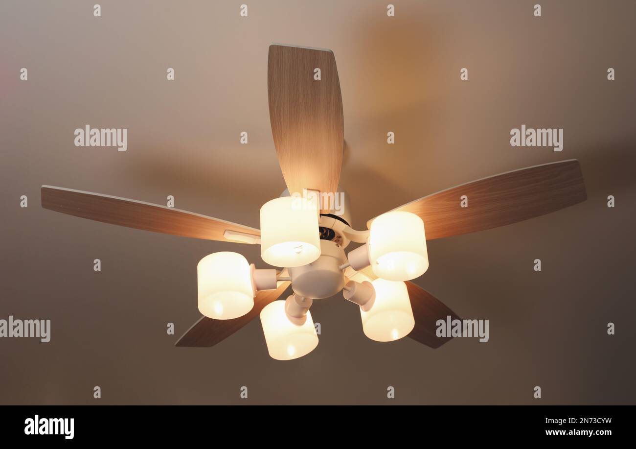 Modern ceiling fan with lamps indoors, below view Stock Photo - Alamy