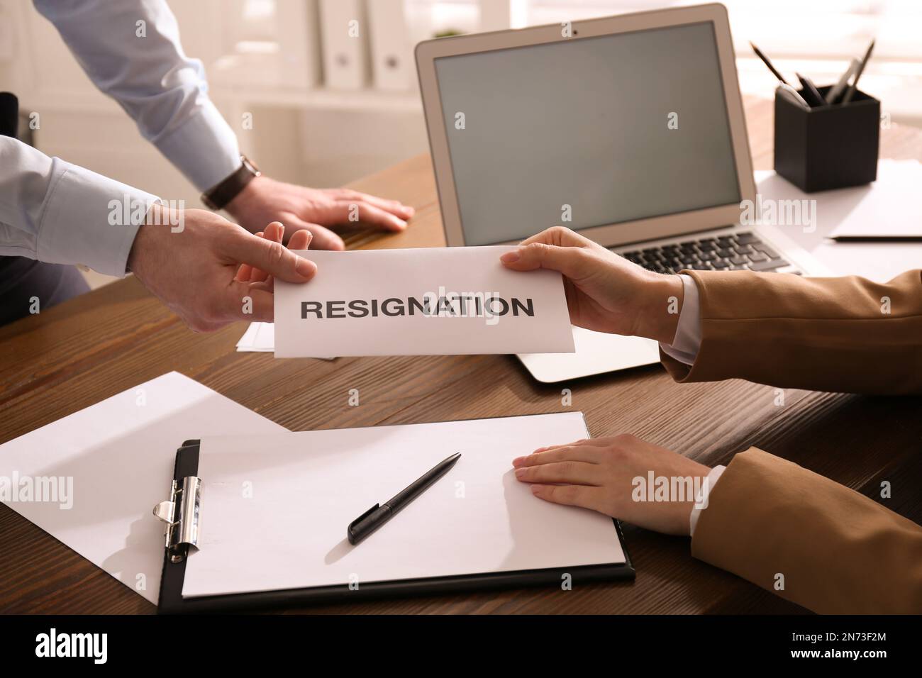Employee giving resignation letter to boss in office, closeup Stock ...
