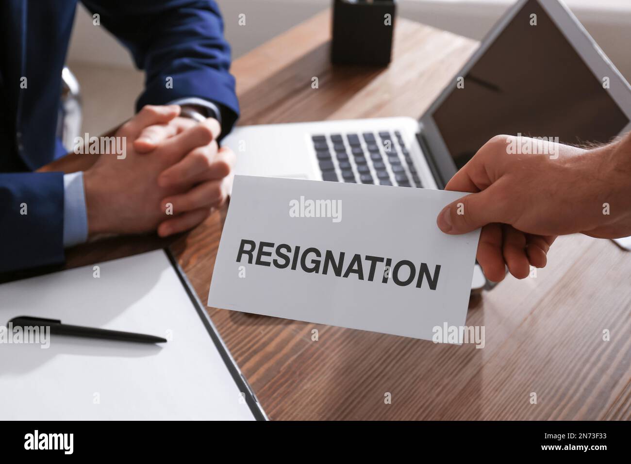 Employee giving resignation letter to boss in office, closeup Stock ...