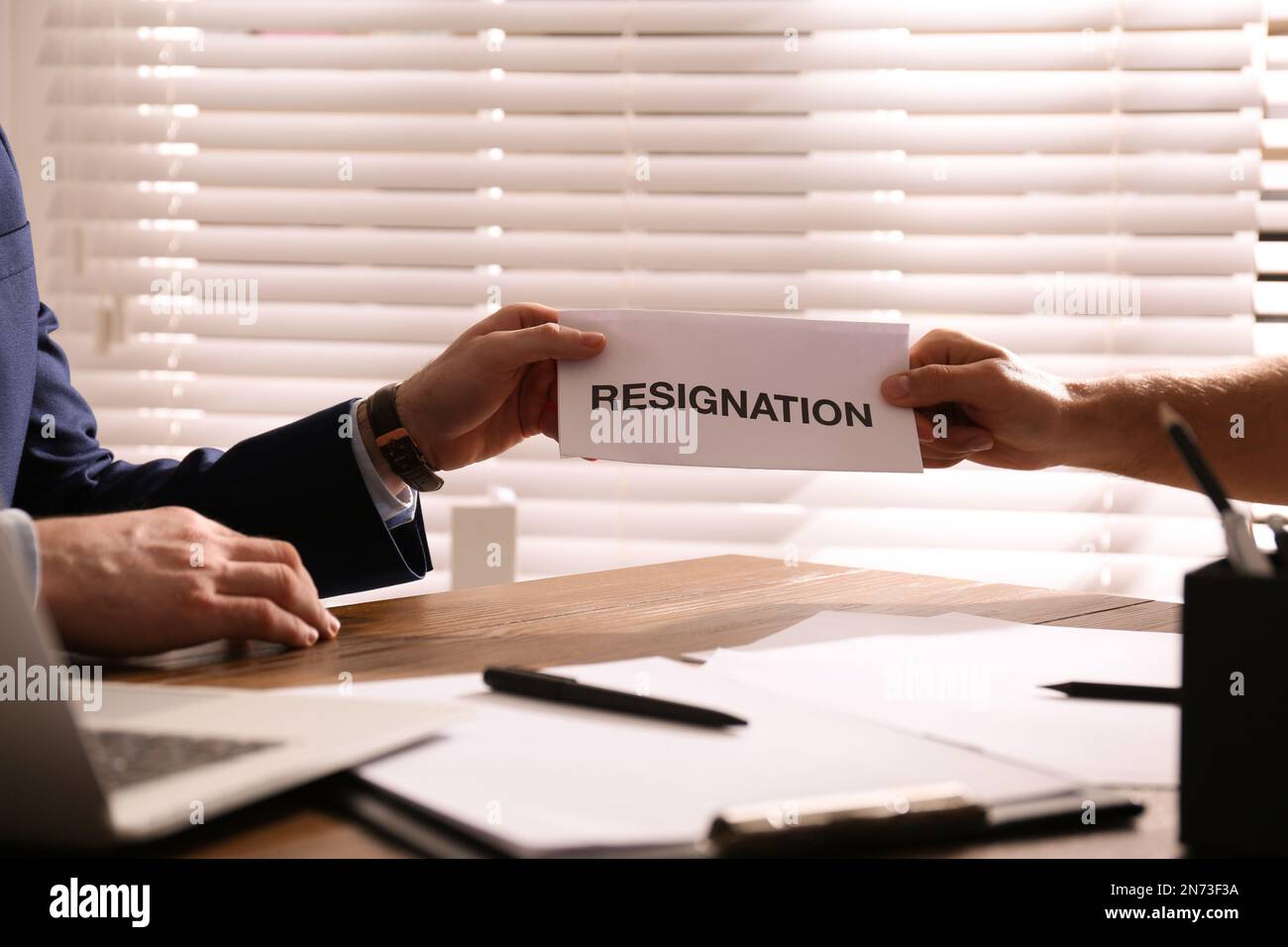 Employee giving resignation letter to boss in office, closeup Stock ...