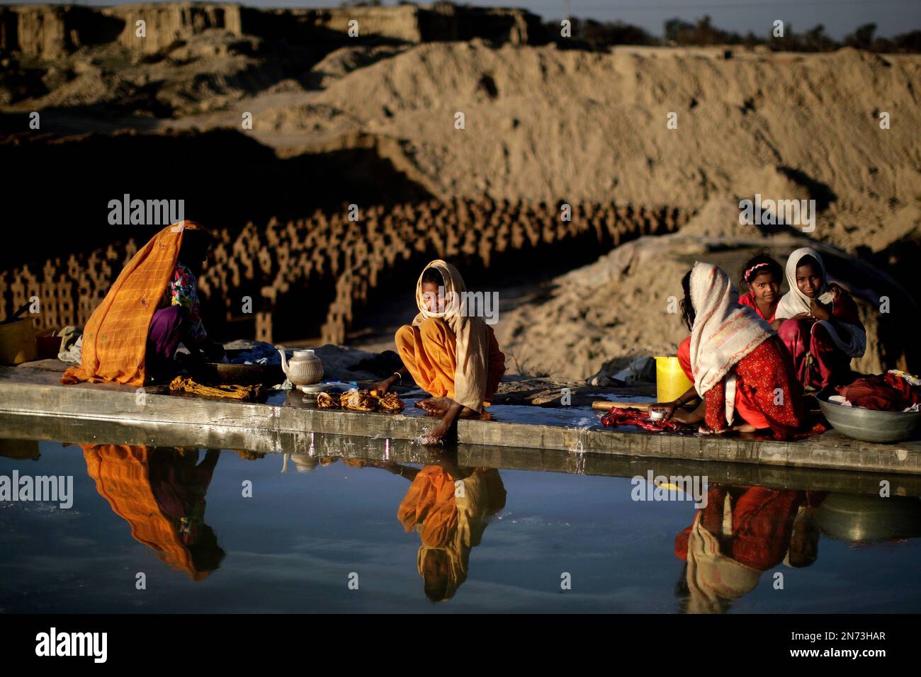 In this Thursday, March 7, 2013 photo, a Pakistani woman and her ...