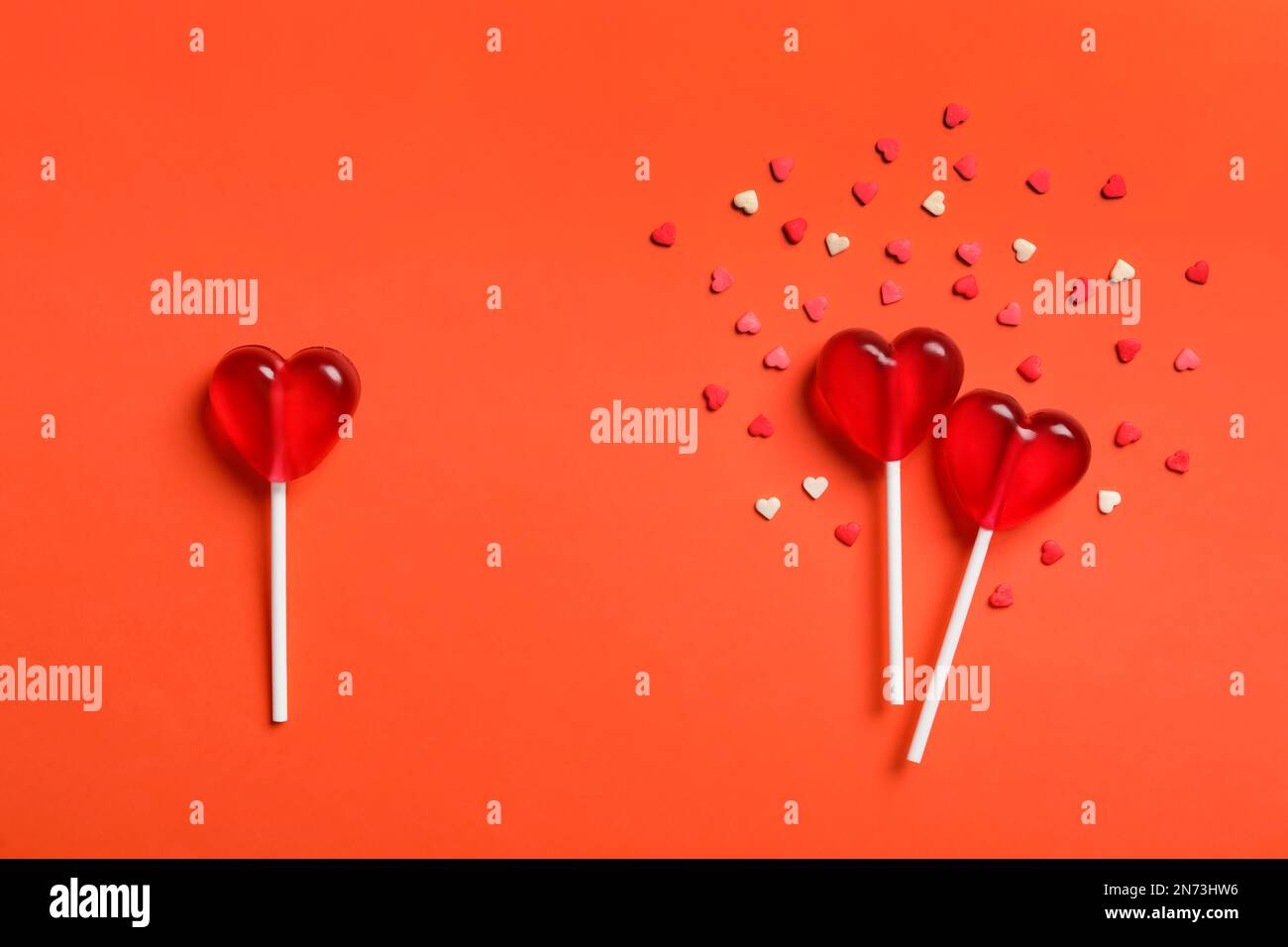 Flat lay composition with sweet heart shaped lollipops and sprinkles on ...