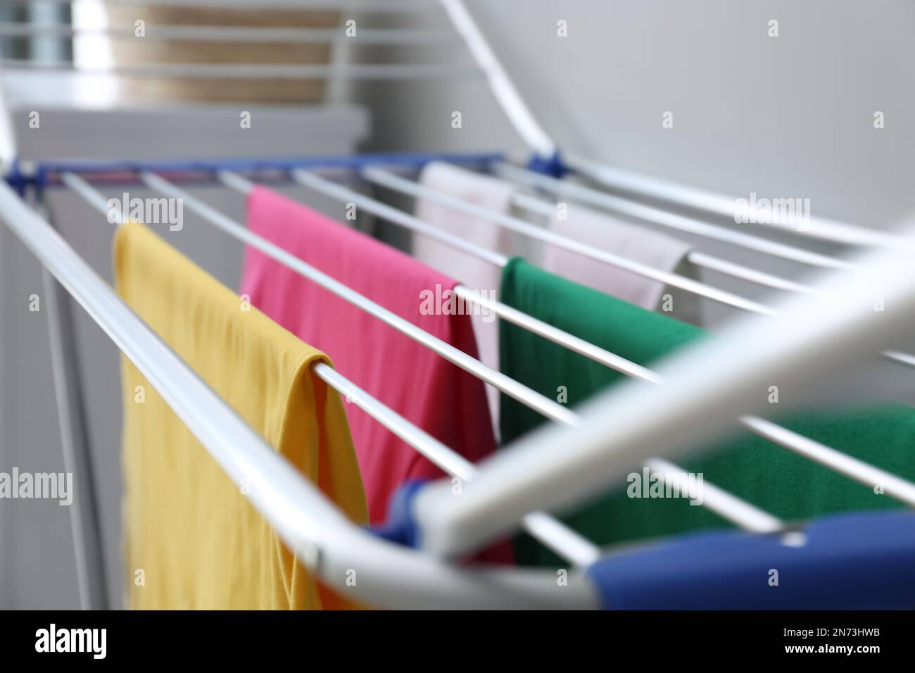 Clean laundry hanging on drying rack indoors, closeup Stock Photo - Alamy