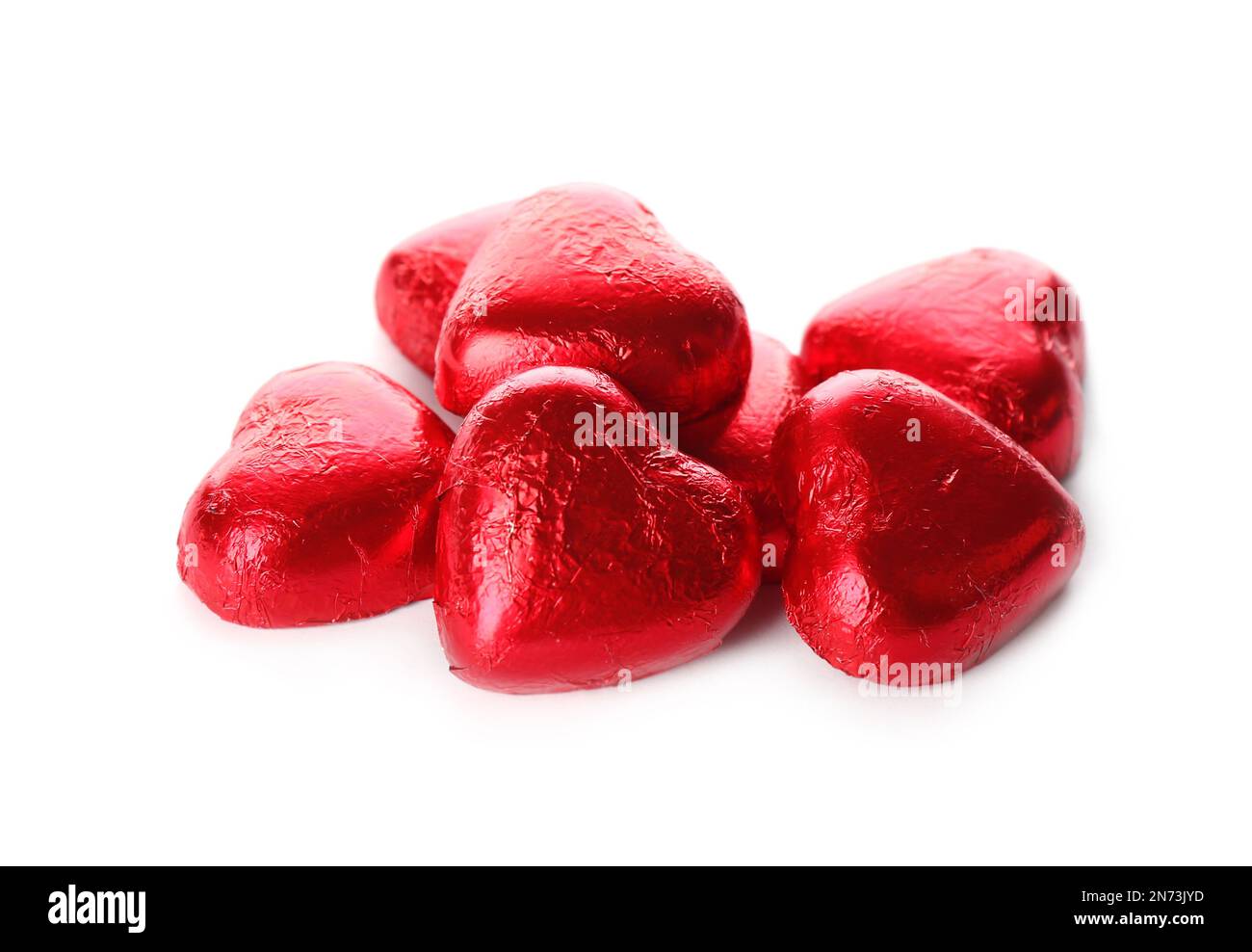 Heart shaped chocolate candies in red foil on white background Stock ...