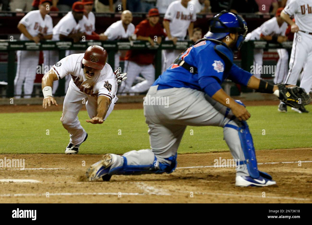 Arizona Diamondbacks' Adam Eaton, left, slides in to score a run ahead ...