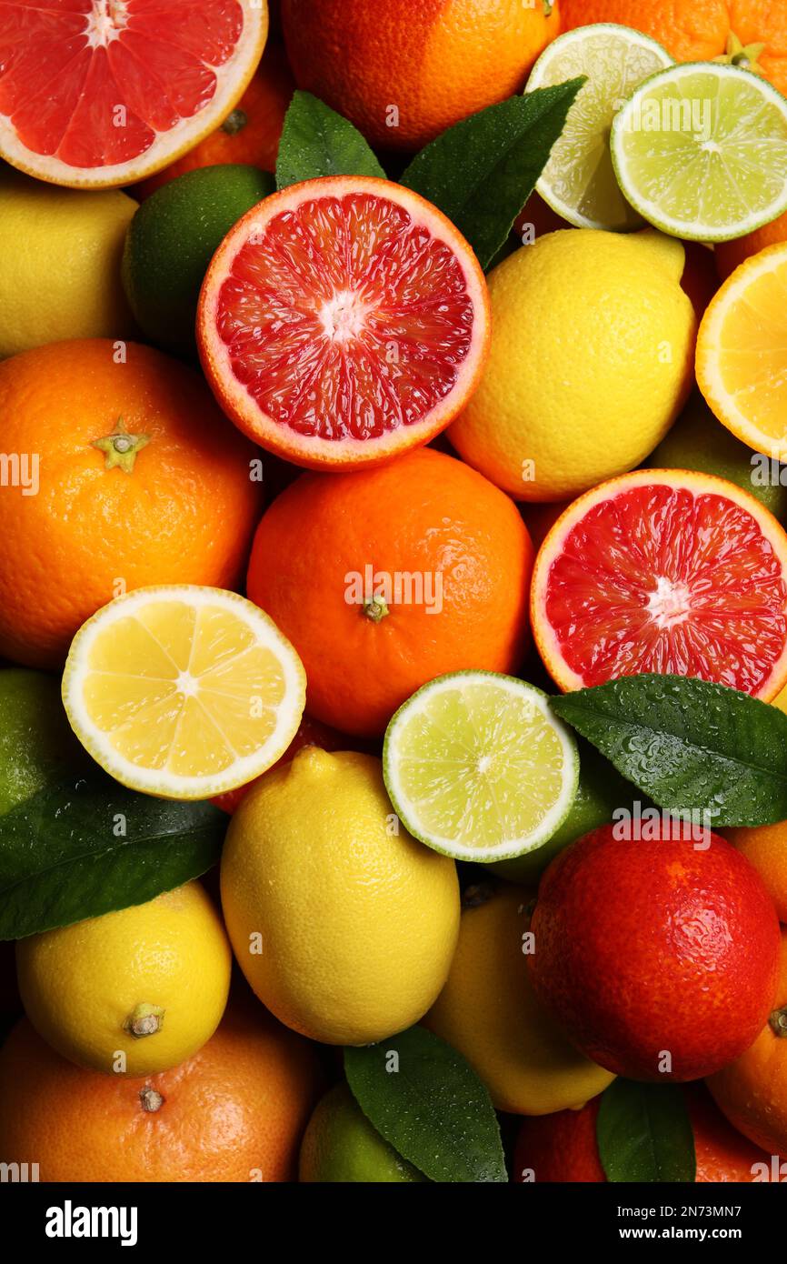 Different ripe citrus fruits as background, closeup Stock Photo - Alamy