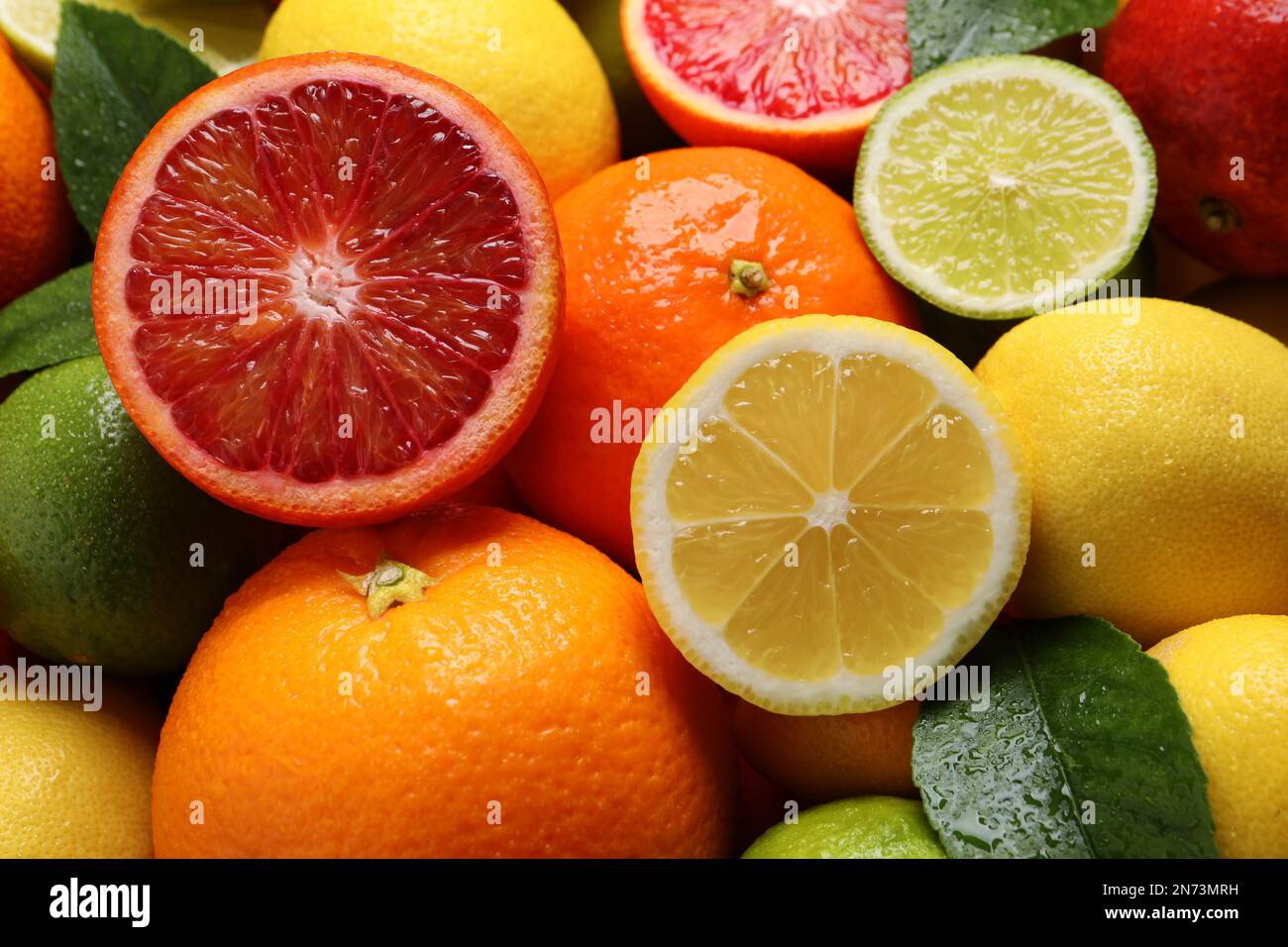 Different ripe citrus fruits as background, closeup Stock Photo - Alamy
