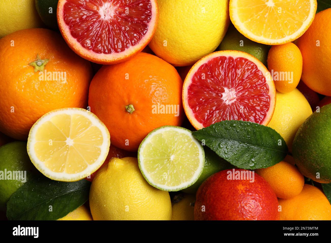 Different ripe citrus fruits as background, closeup Stock Photo - Alamy
