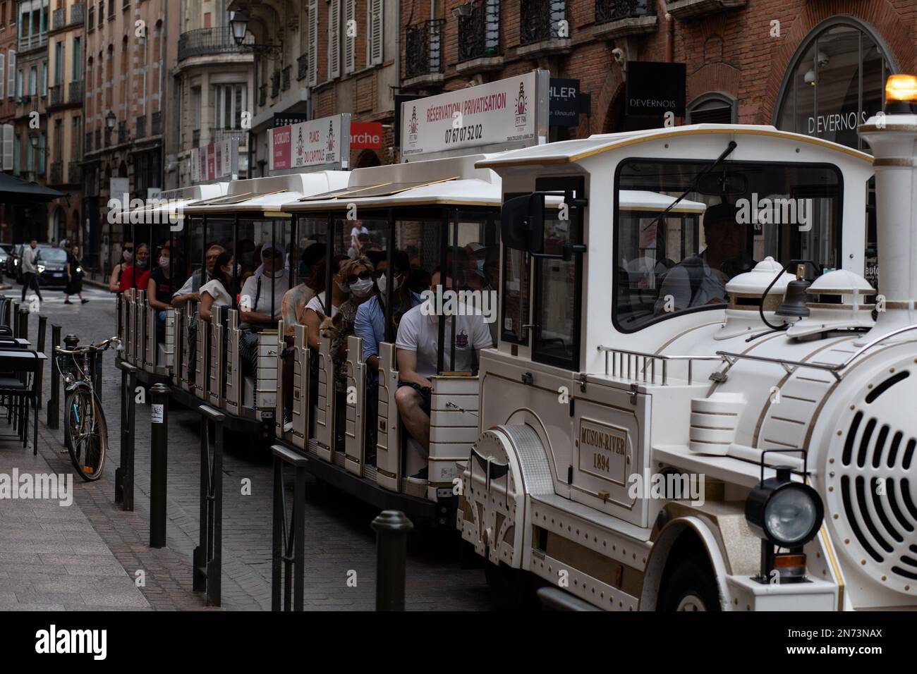 Tourist train driving through the center of Toulouse , France Stock ...