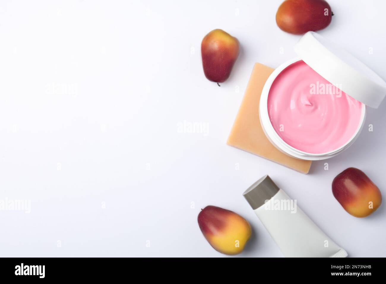 Fresh ripe palm oil fruits and cosmetic products on white background ...
