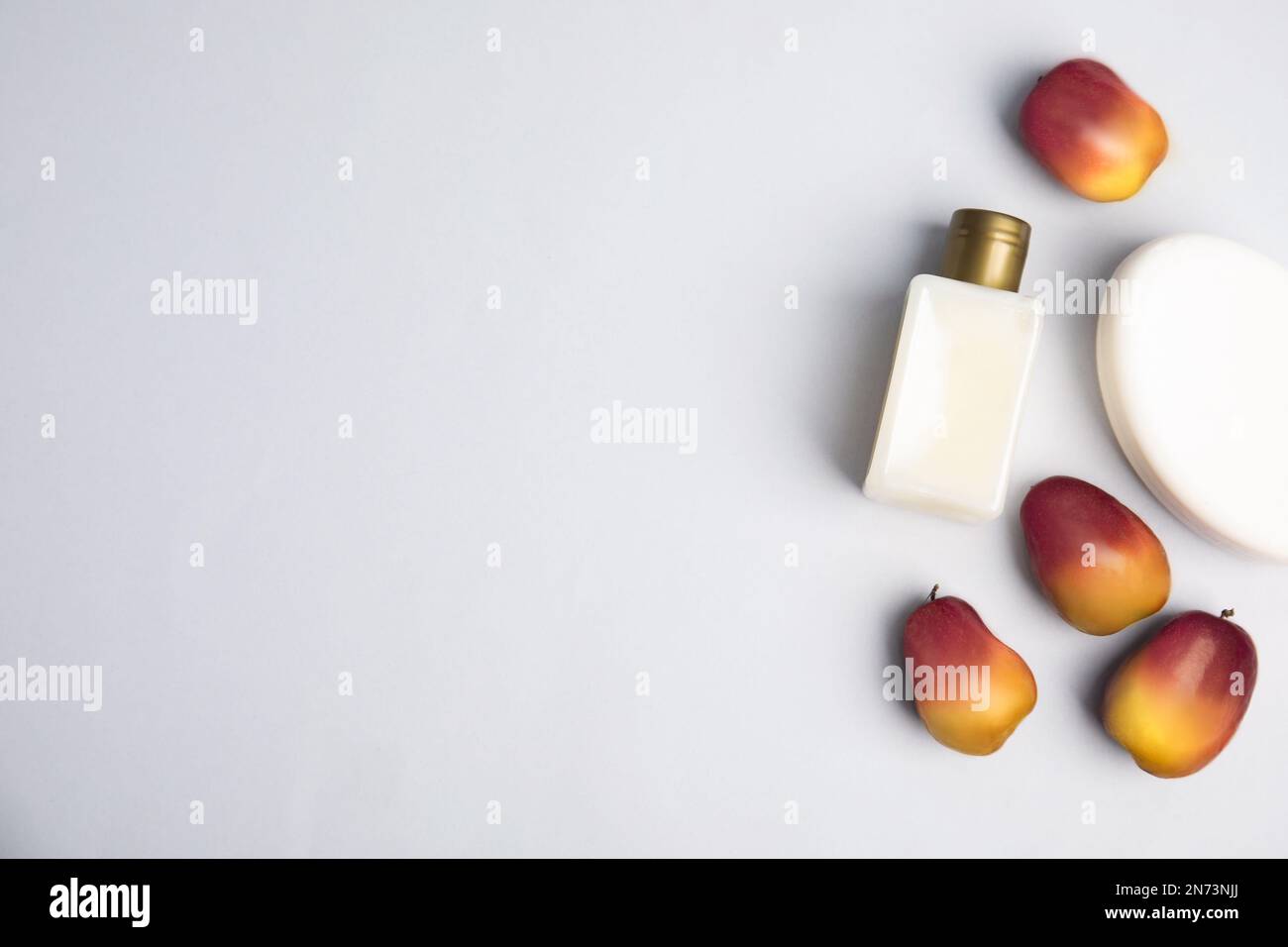 Fresh ripe palm oil fruits and cosmetic products on white background ...
