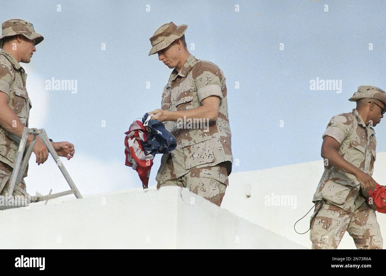 Marine Sgt. Millard Smith of Dublin, Va., prepares to fold a crumpled ...