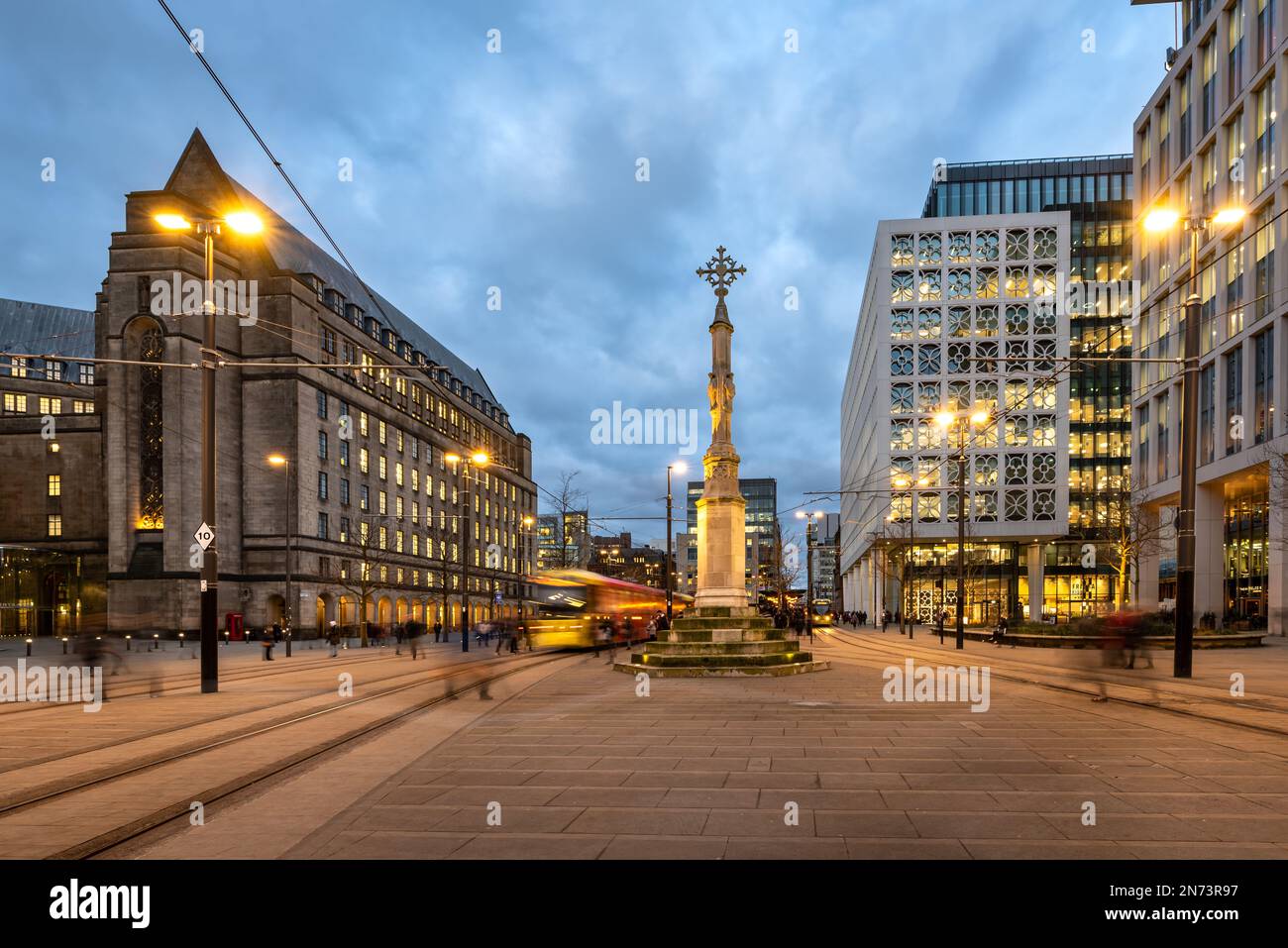 Metro tram passing beside St Peter cross in St Peter Square at ...