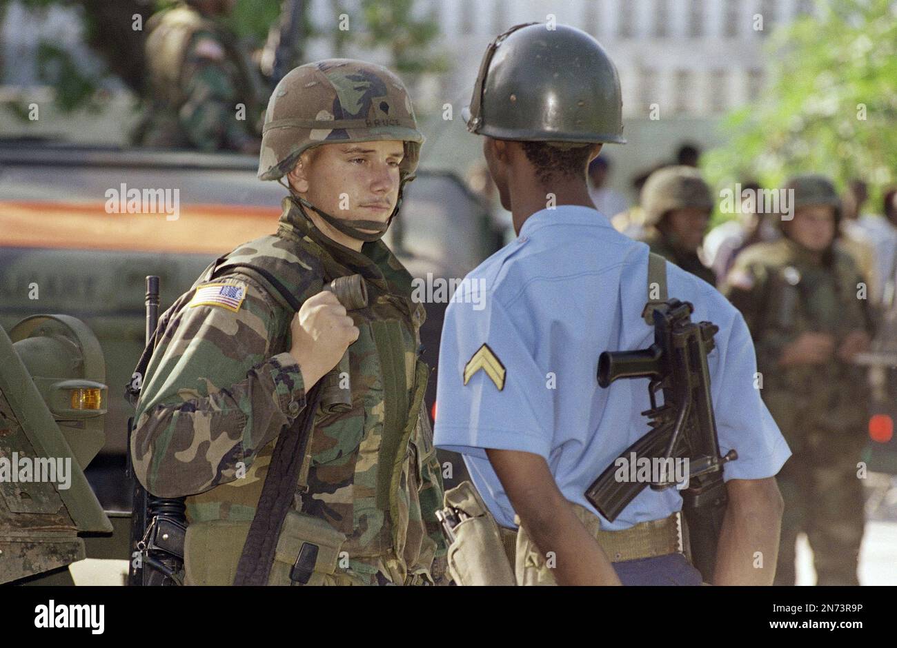 U.S. Army Spc. Kyle Bruce, of Antioch, Calif., talks with a Haitian ...