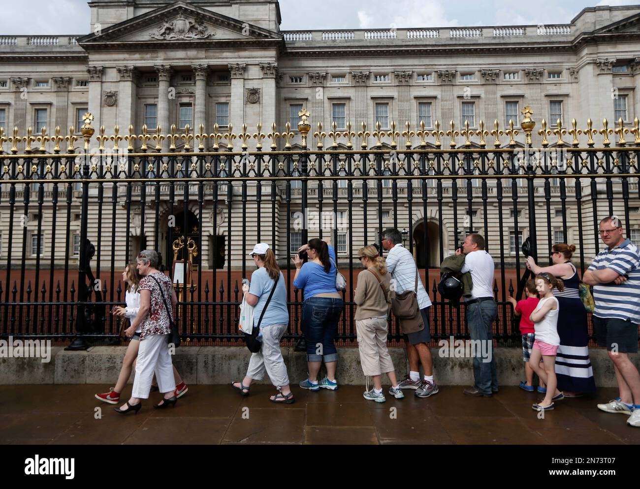People queue to look at a notice proclaiming the birth of a baby boy of ...