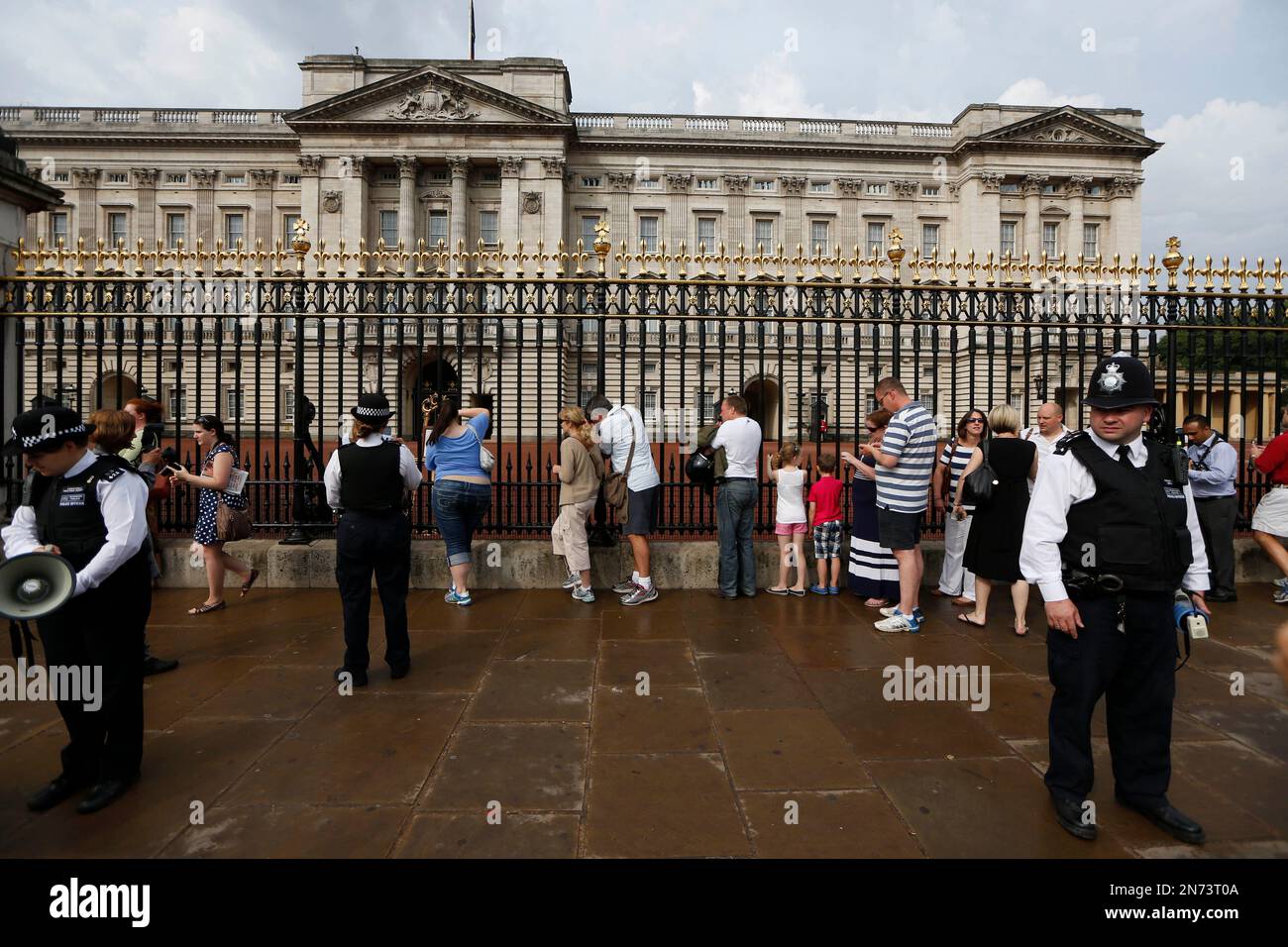 People queue to look at a notice proclaiming the birth of a baby boy of ...