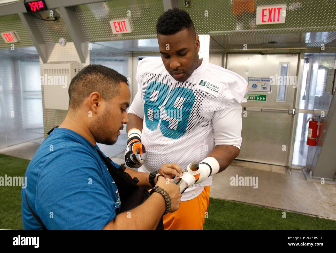 Miami Dolphins defensive end Tracy Robertson has his hand tapped up ...