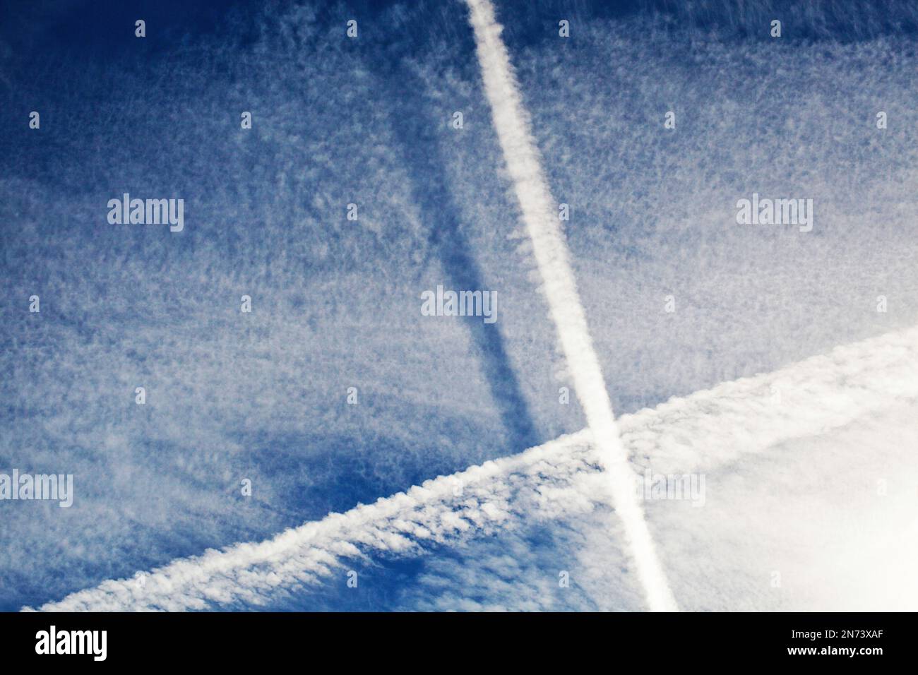 Contrails with shadow in front of the ice clouds in the sky Stock Photo ...