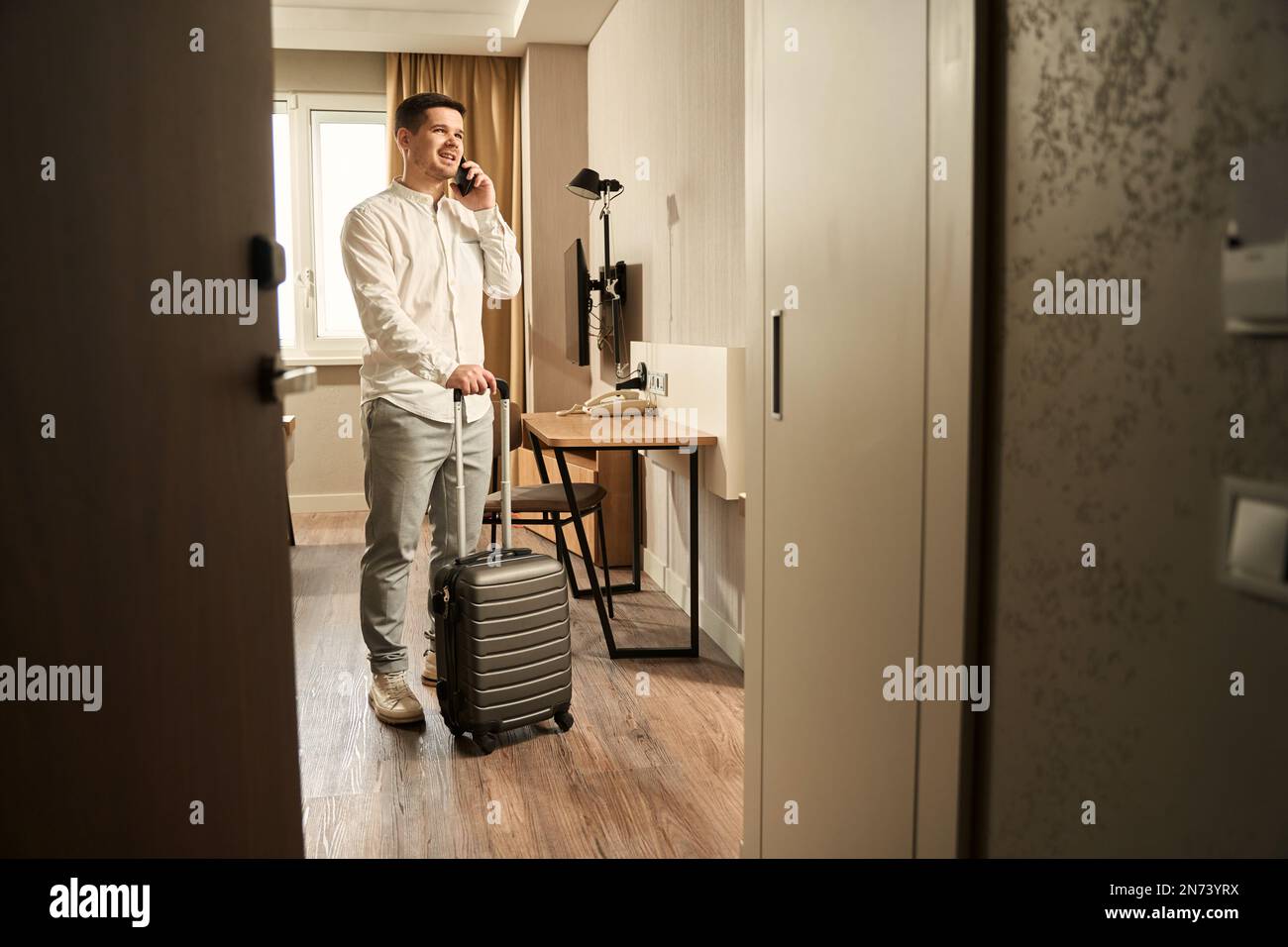 Man settled in a comfortable hotel room Stock Photo - Alamy