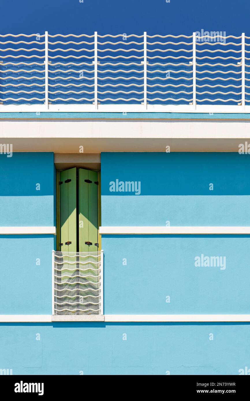 Turquoise house with green wooden door in coastal town of Caorle ...