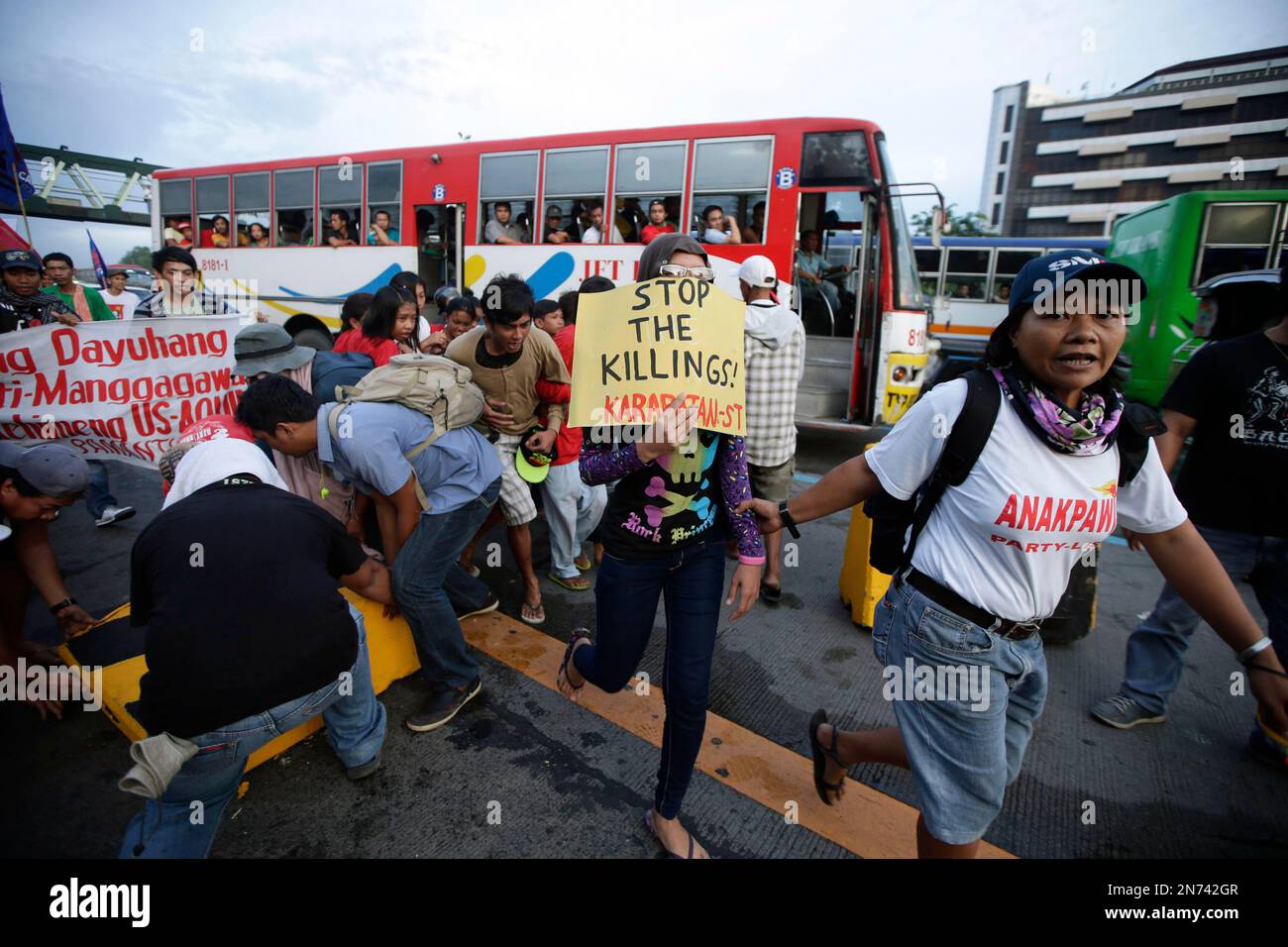 Protesters remove the barricade put up by police to pave the way for ...