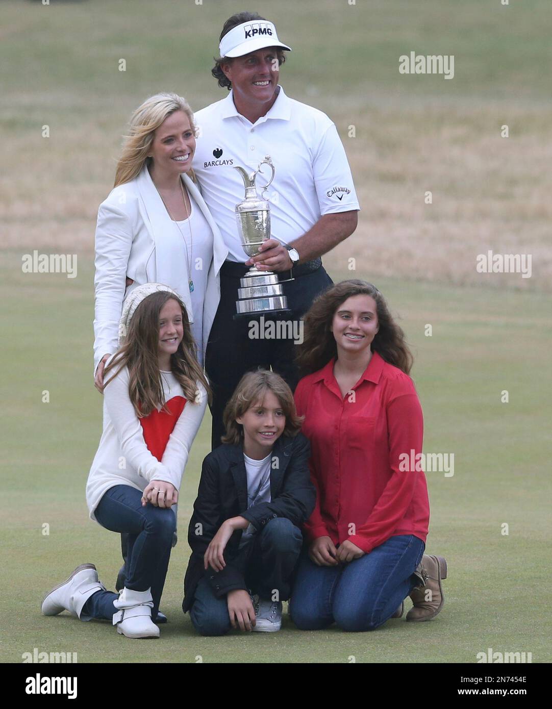 Phil Mickelson of the United States holds up the Claret Jug trophy and ...