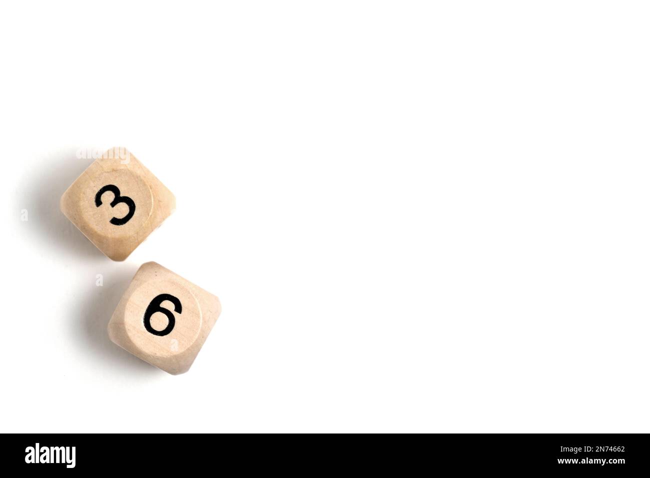 Pair of wooden dice for board games with numbers three and six white ...