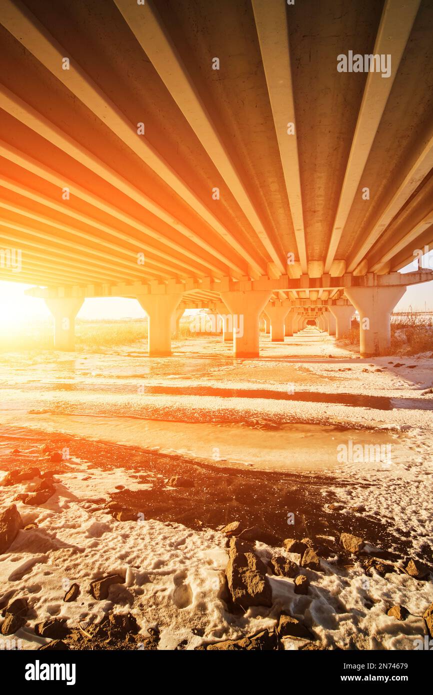 Columns motor transport bridge background sunset and a frozen river ...