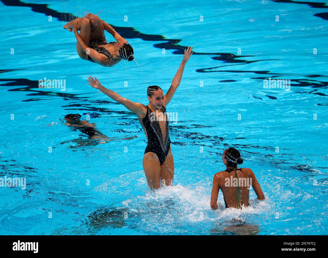 The Spainish team perform their routine in the synchronised swimming ...