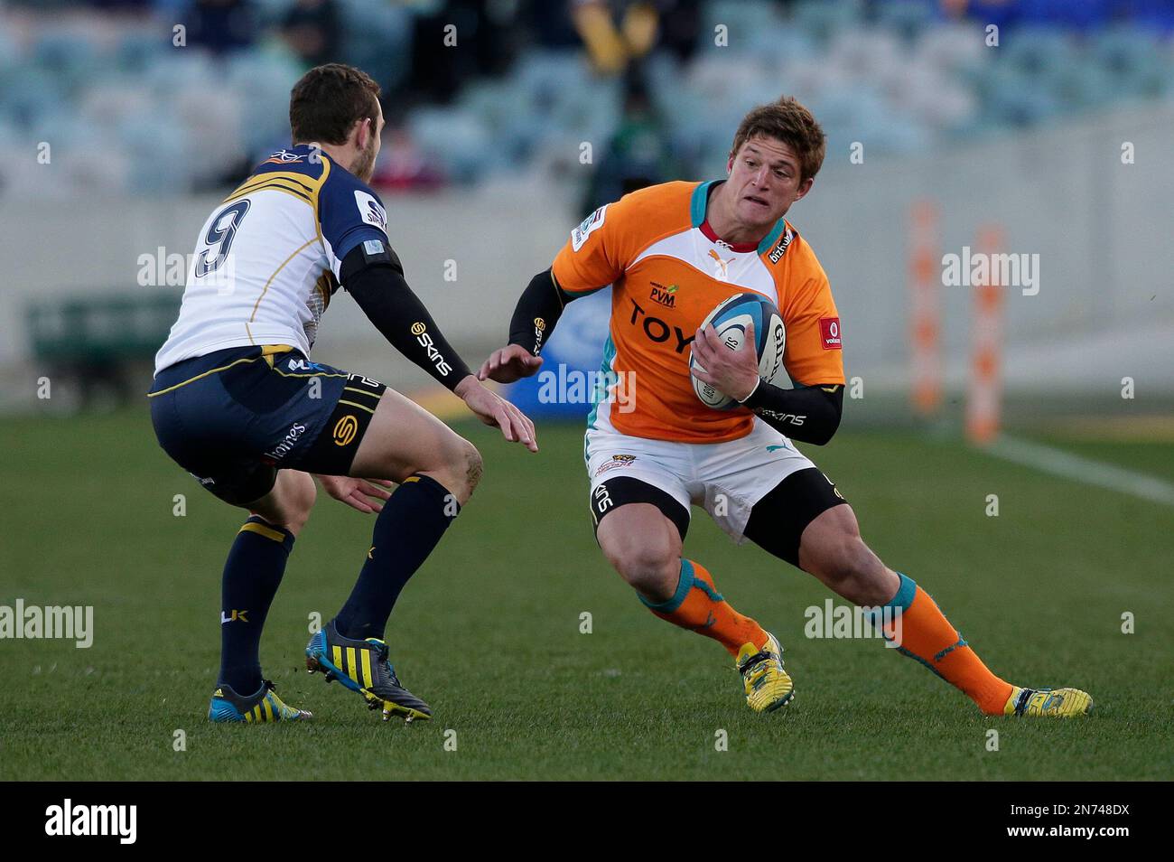 South Africa's Cheetahs' Johann Sadie, right, tries to side step ACT ...