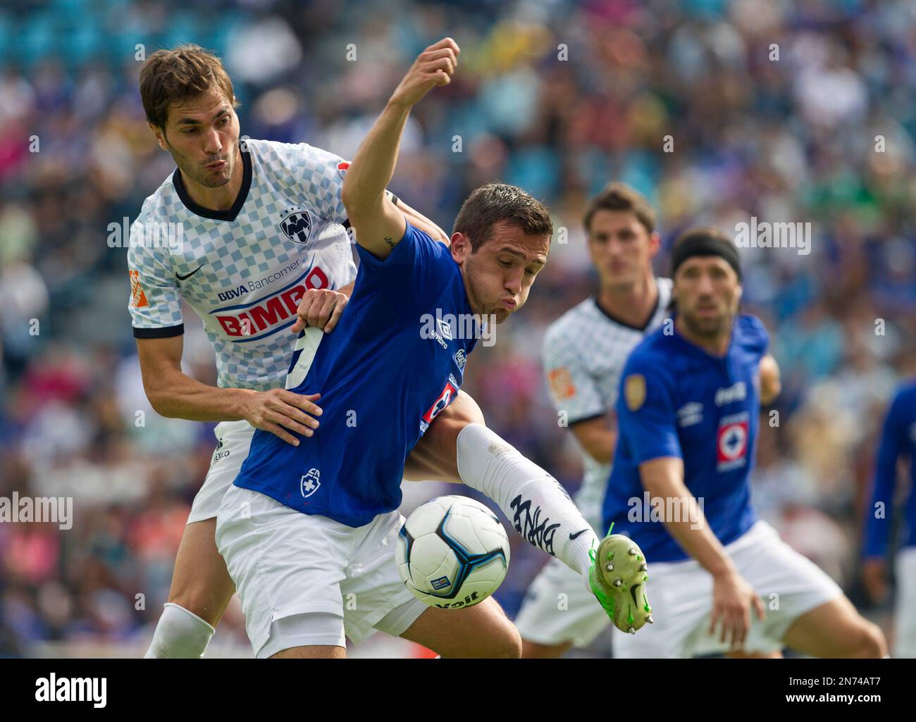 Monterrey's Jose Maria Basanta, top, fights for the ball with Cruz Azul ...