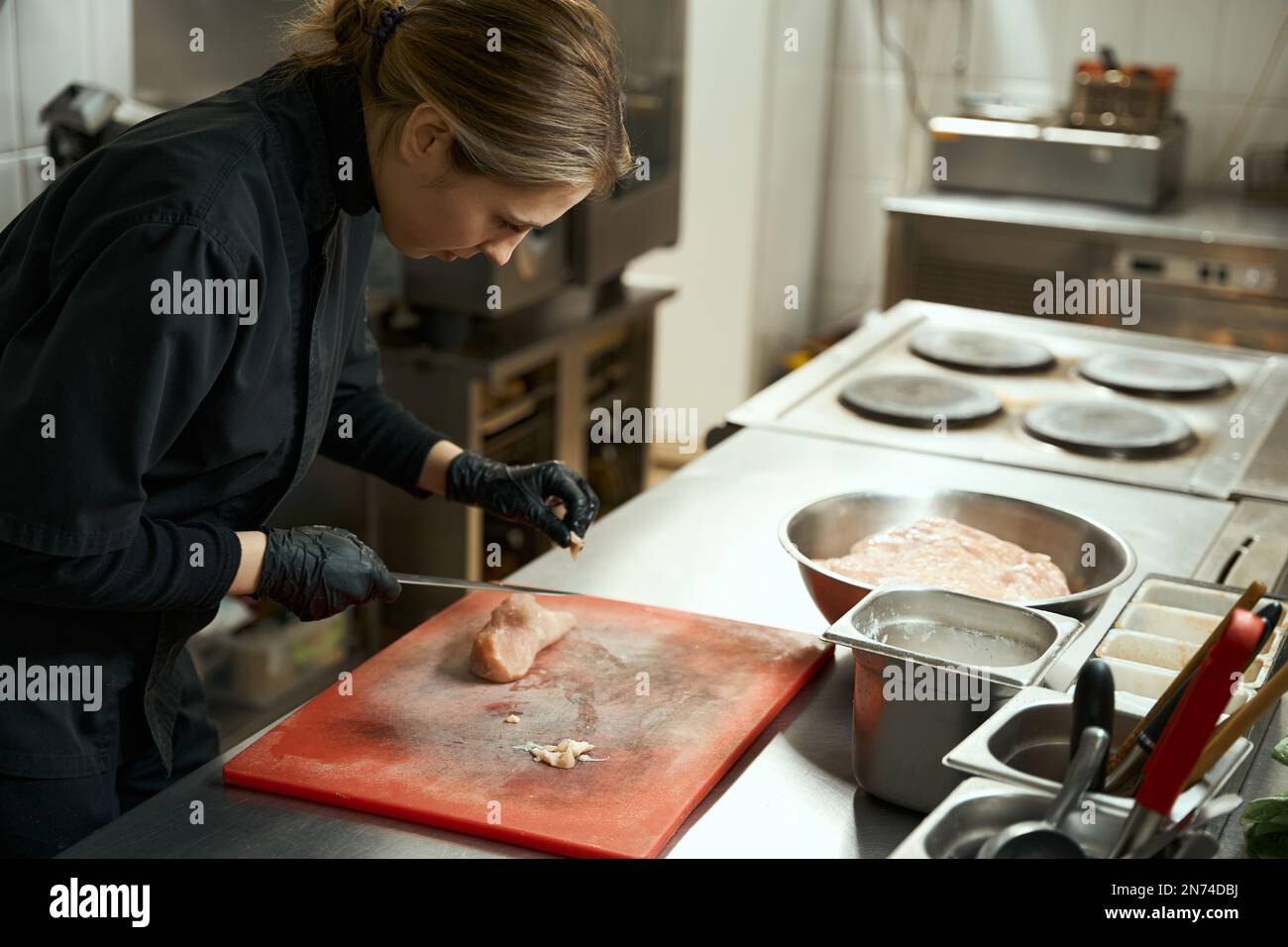 Female chef cuts raw chicken hi-res stock photography and images - Alamy